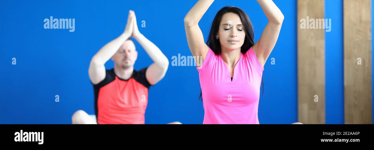 Woman performing exercise with hands up Stock Photo - Alamy