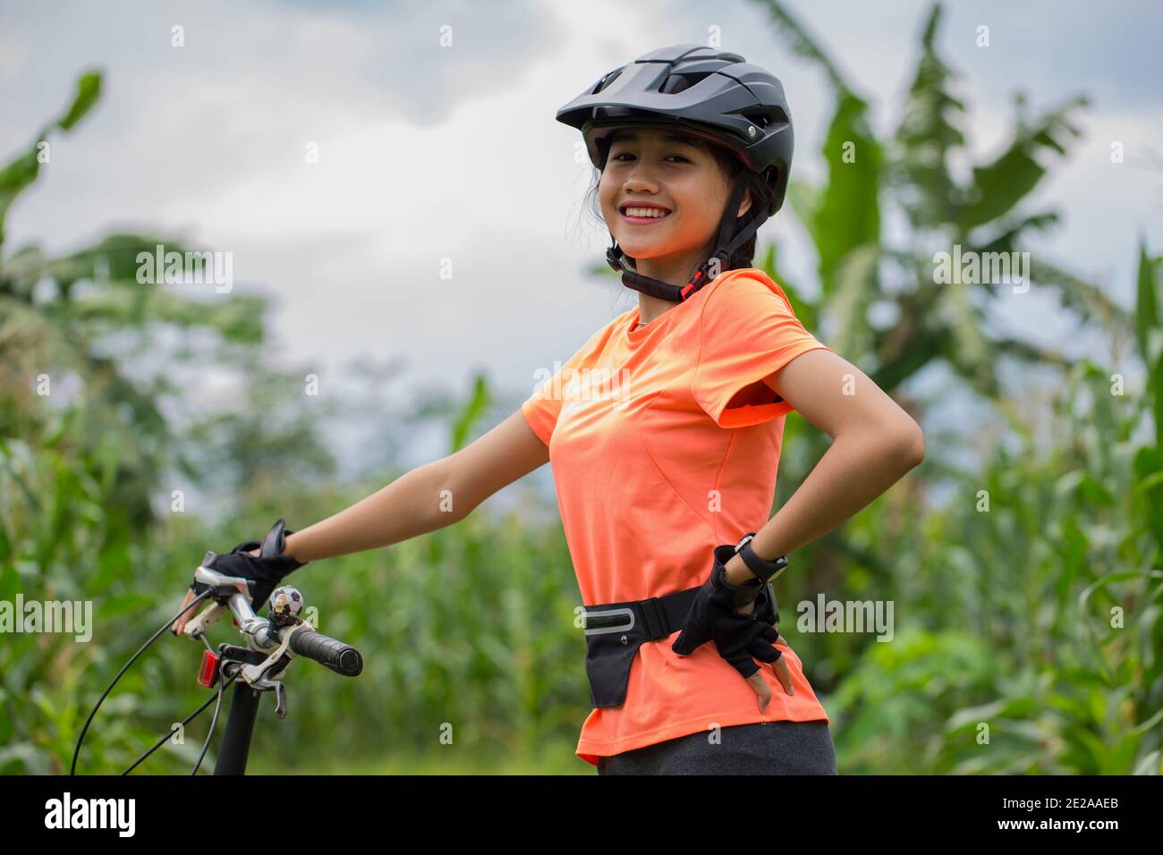 portrait of young asian woman cyclist with bike Stock Photo - Alamy