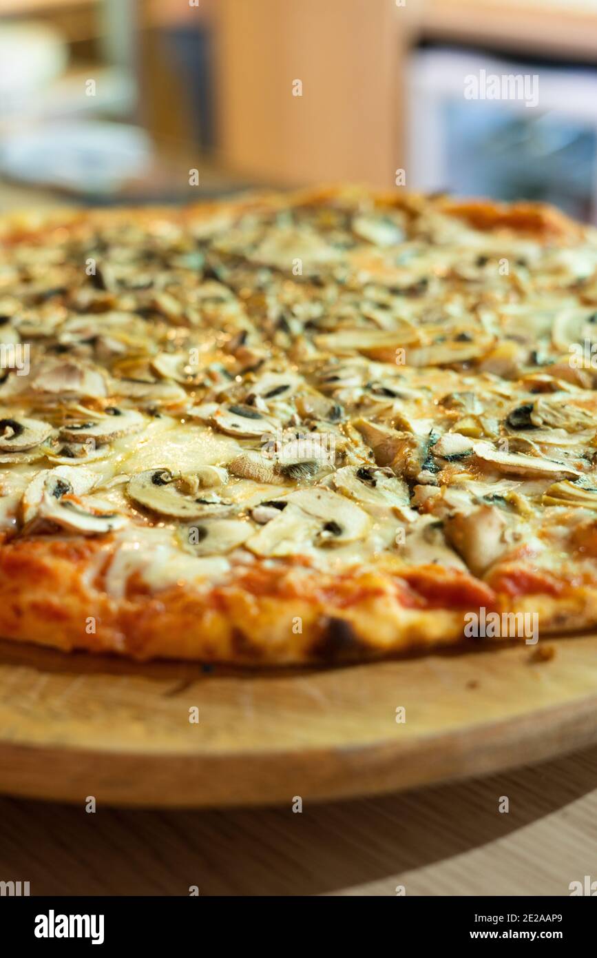 Beautiful and tasty Italian pizza on wood plate Stock Photo - Alamy