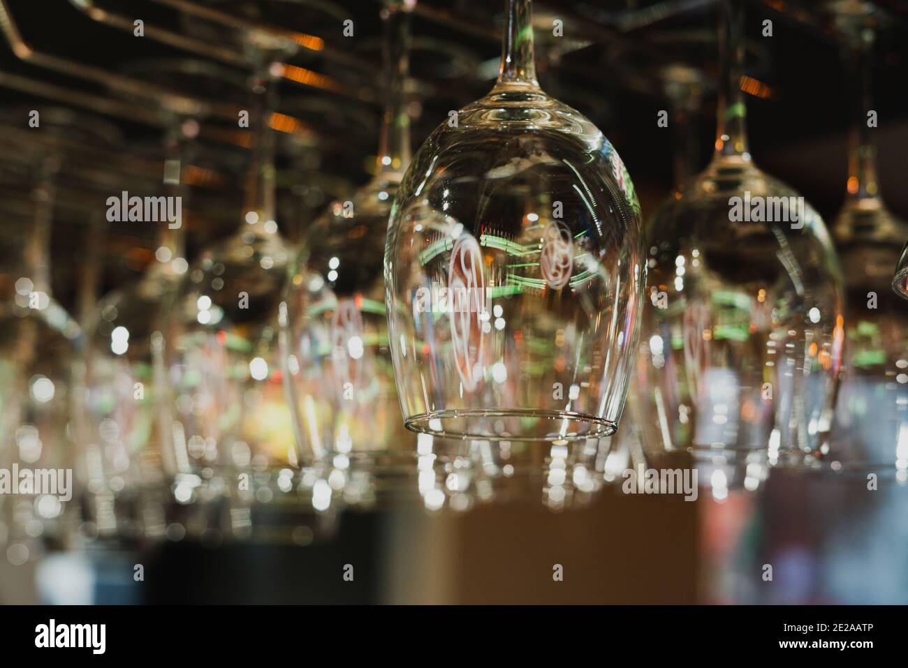 Beautiful glasses hanging in night clubs bar with only one glass in ...