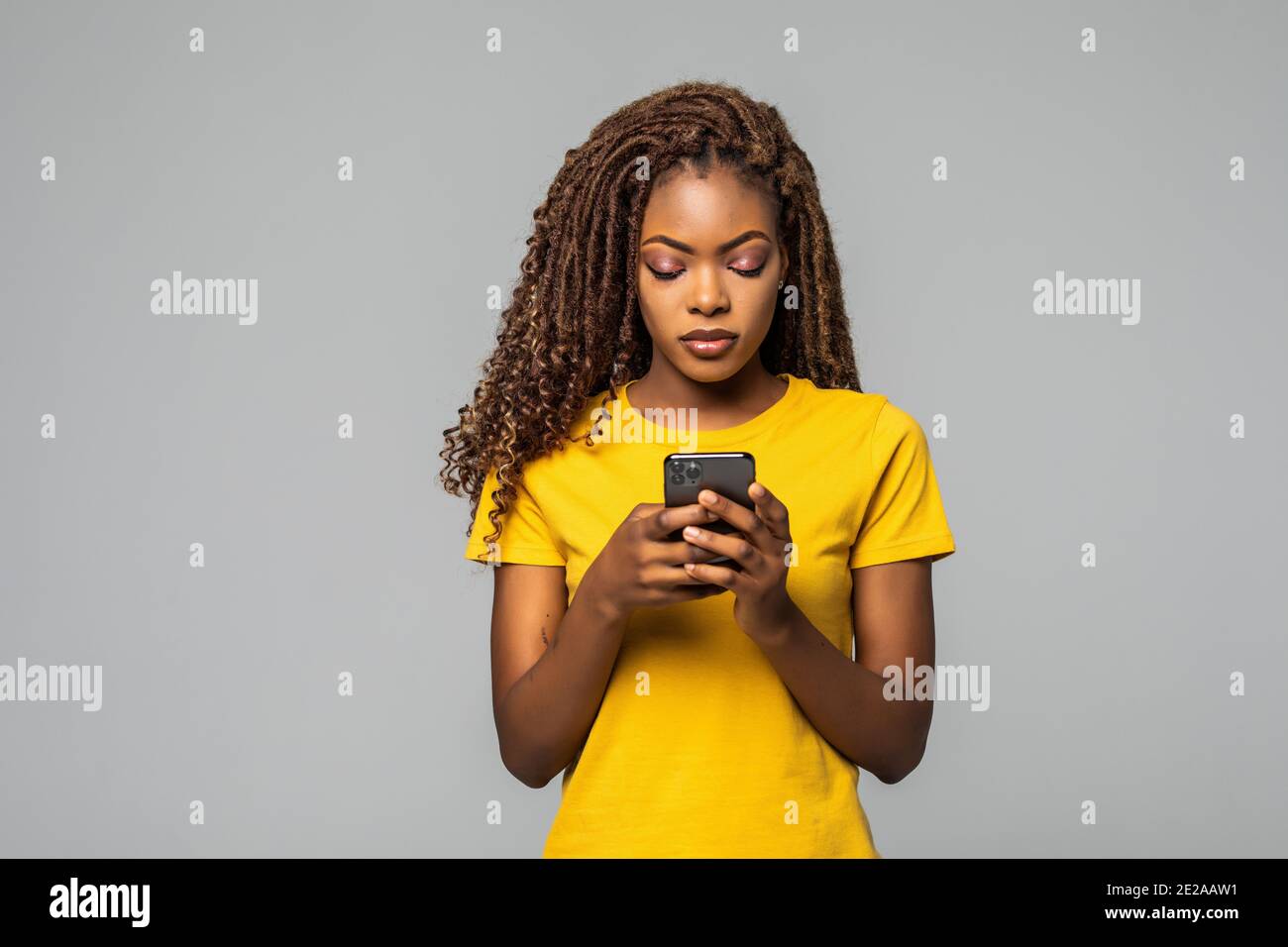 Excited woman texting on her phone - isolated over white background ...