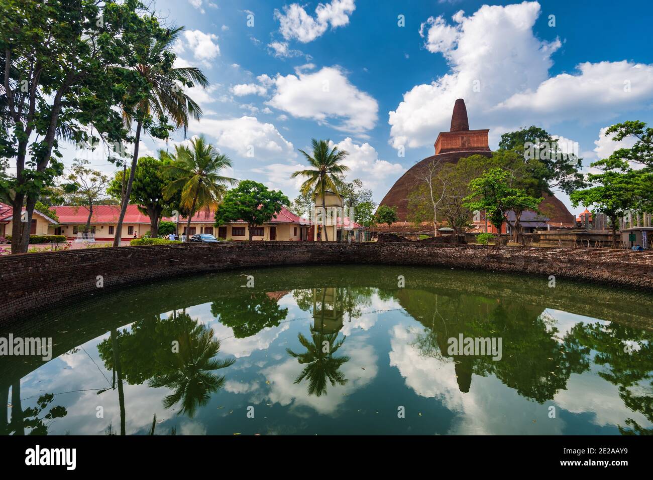 Reflection in a circular pon ofGiant red brick stupa of Abayagiri ...