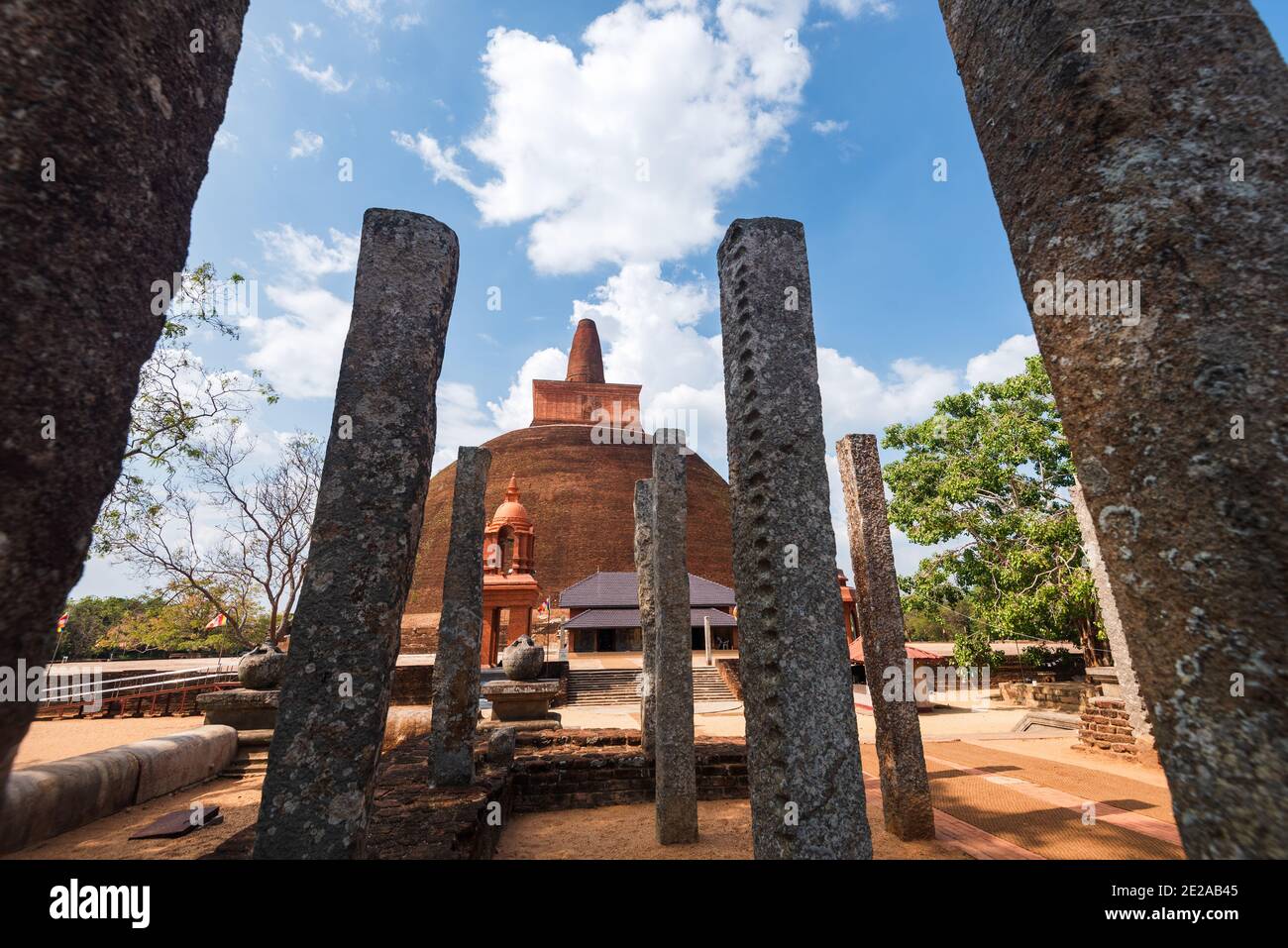 Pillars in front of the Giant red brick stupa of Abayagiri Monastery ...