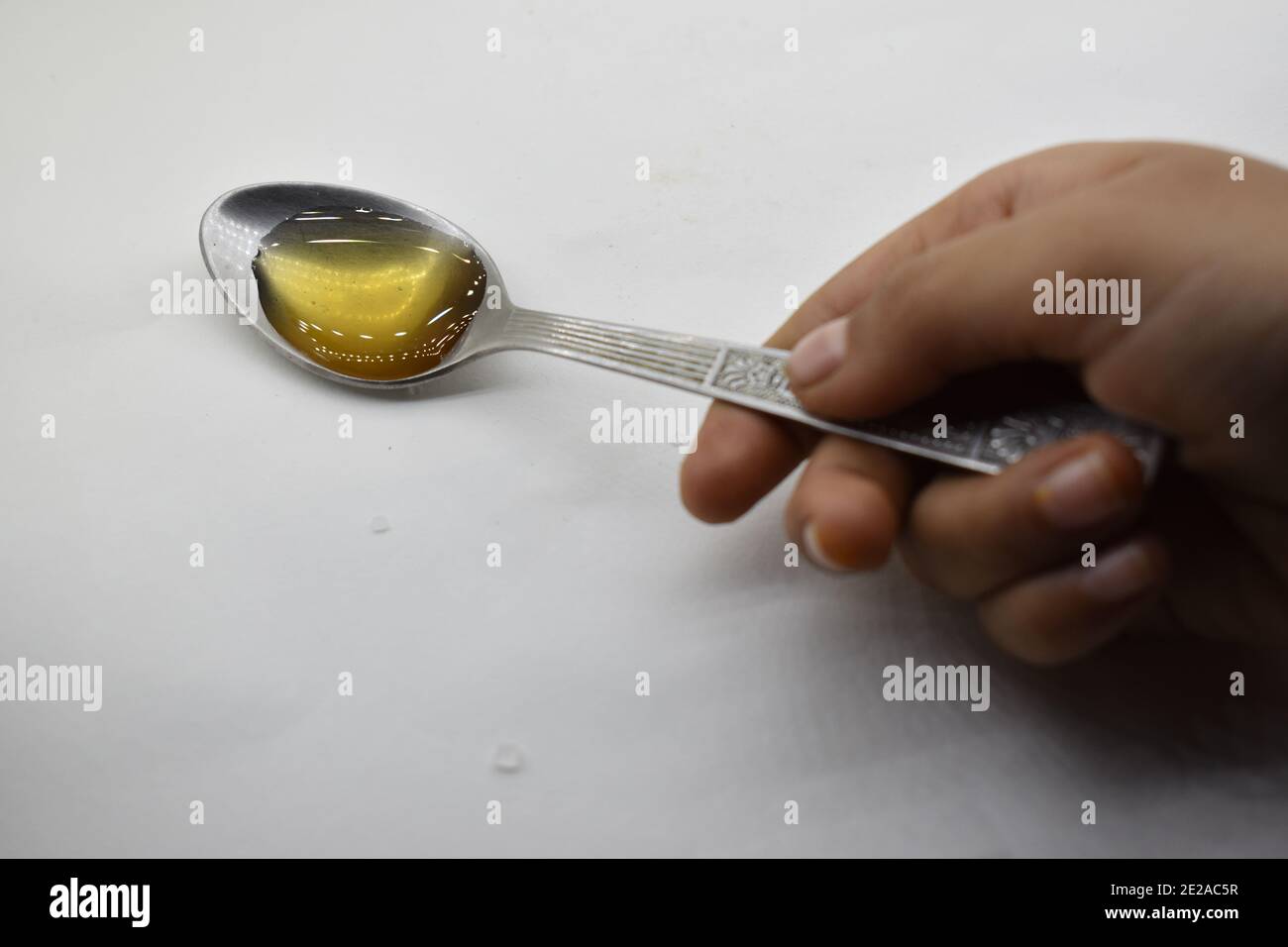 Spoon of cooking oil isolated on white background Stock Photo - Alamy