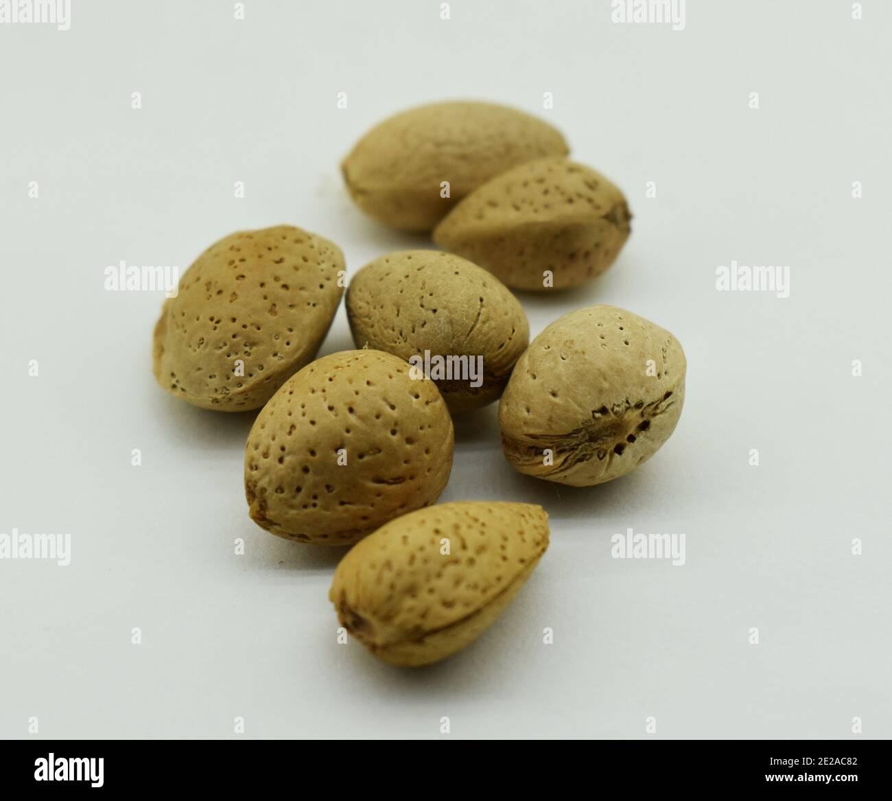 Closeup shot of almonds with the shell on white background Stock Photo ...