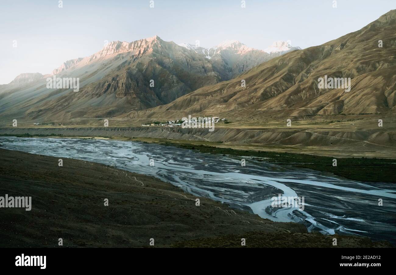 Beautiful river at low water flanked by high Himalayas and view of ...
