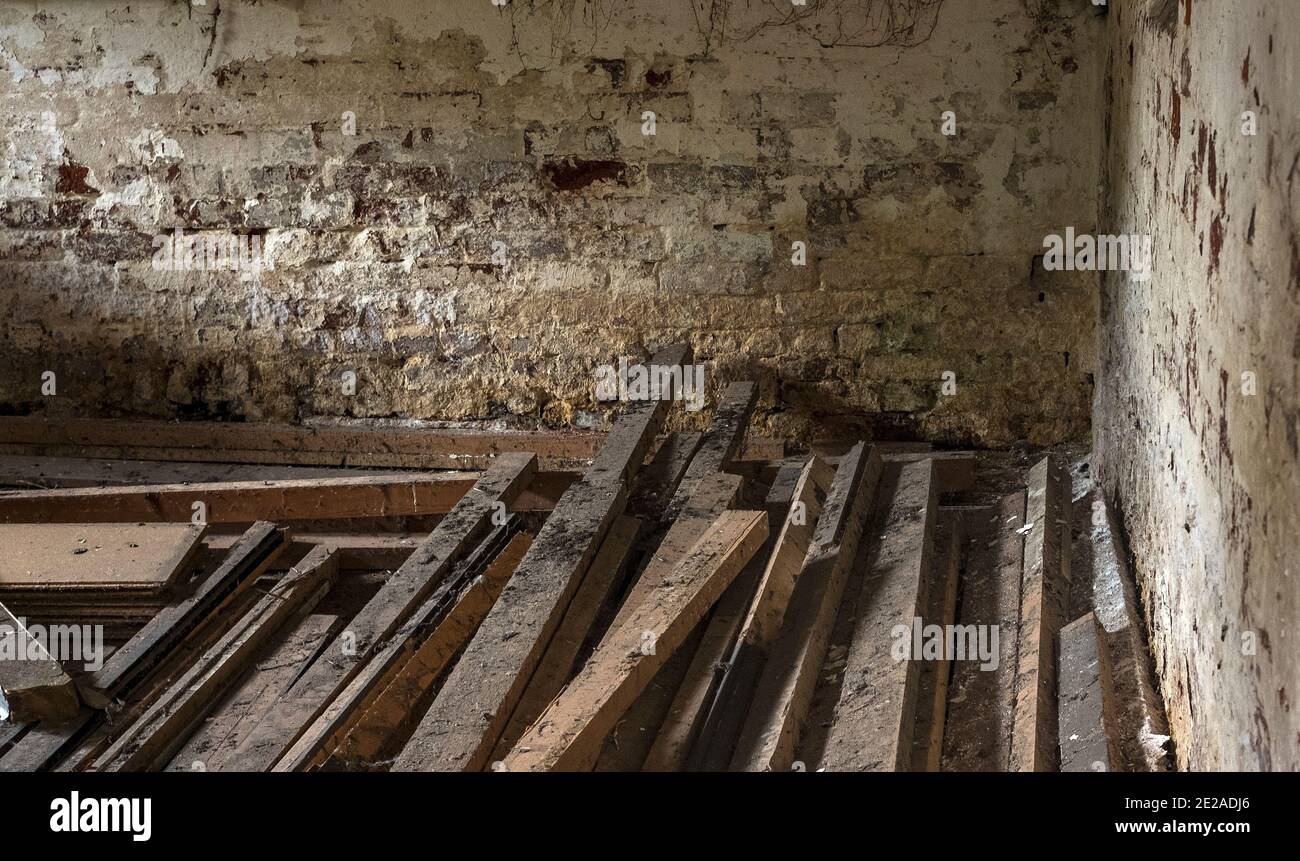 Wood piled up in an brick store room Stock Photo - Alamy