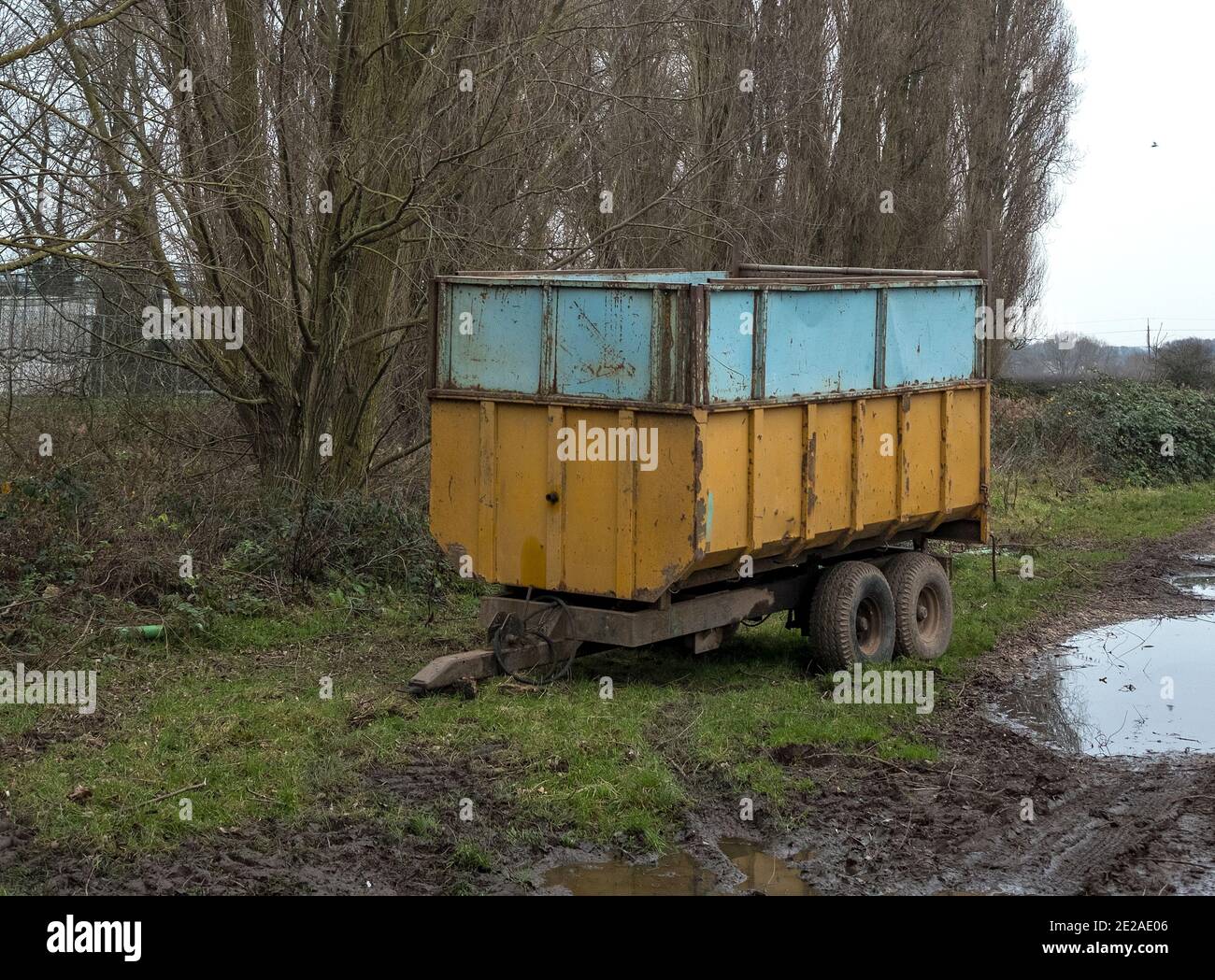 Old farm trailer next to a muddy track Stock Photo - Alamy