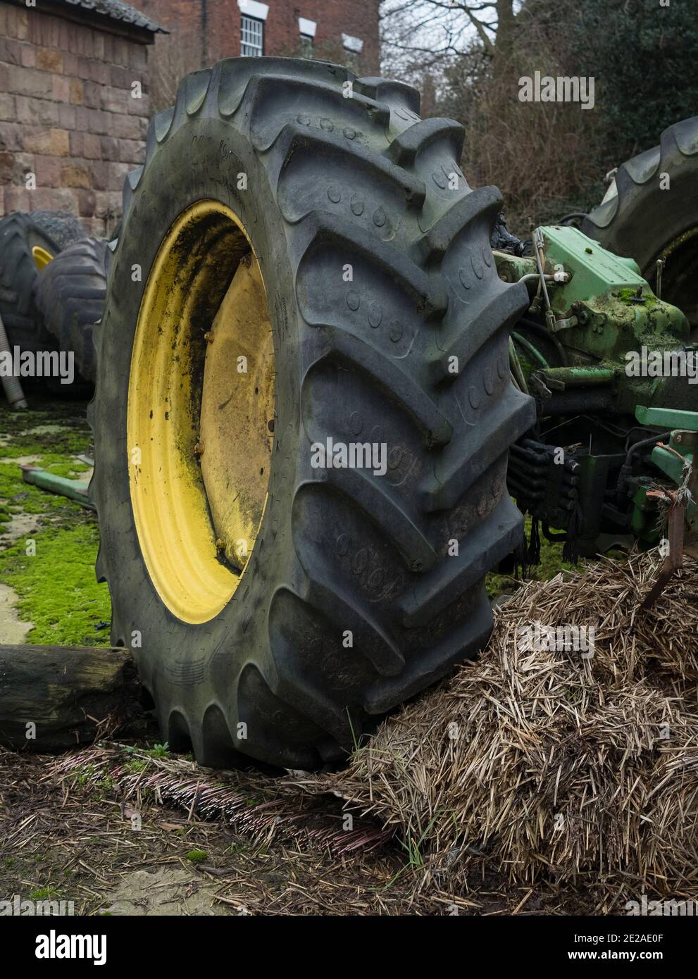 Old tractor tire and wheel standing upright Stock Photo - Alamy