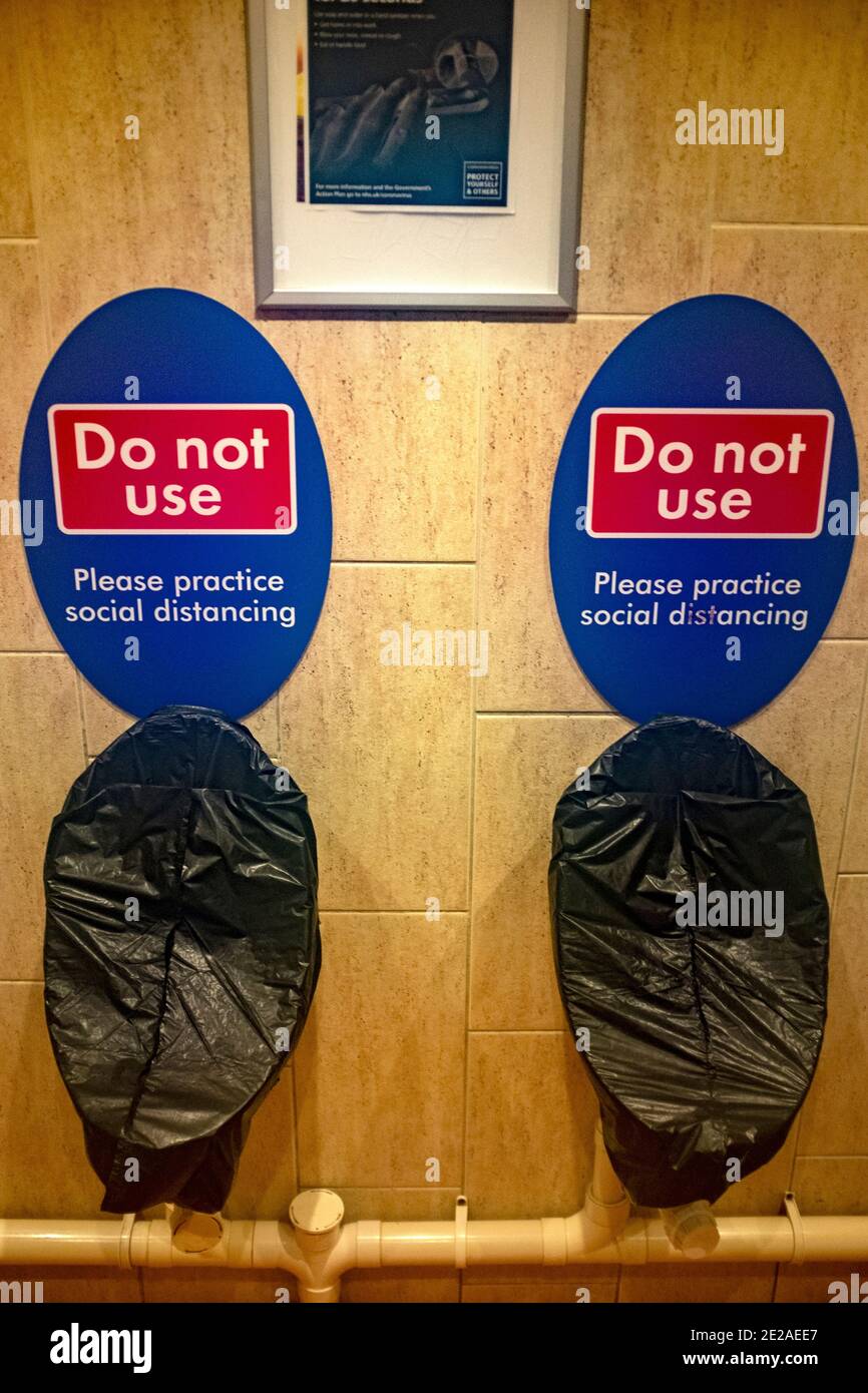 Restricted use of urinals in pub toilet Stock Photo - Alamy