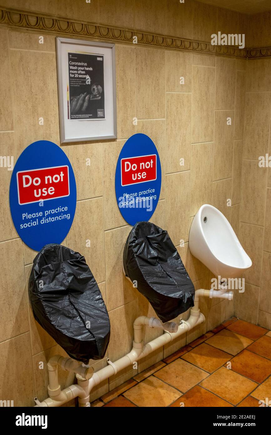 Restricted use of urinals in pub toilet Stock Photo - Alamy