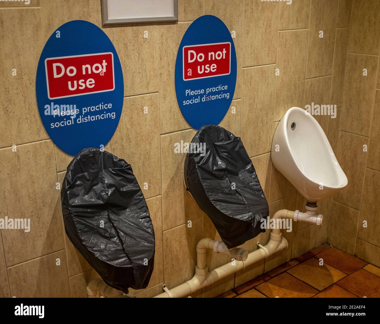 Restricted use of urinals in pub toilet Stock Photo - Alamy