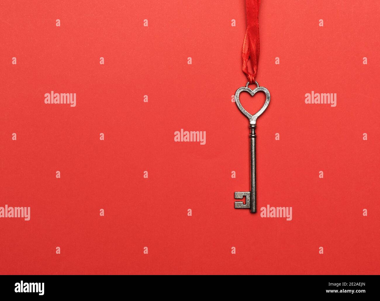metal key hanging on a red ribbon, red background, copy space Stock ...