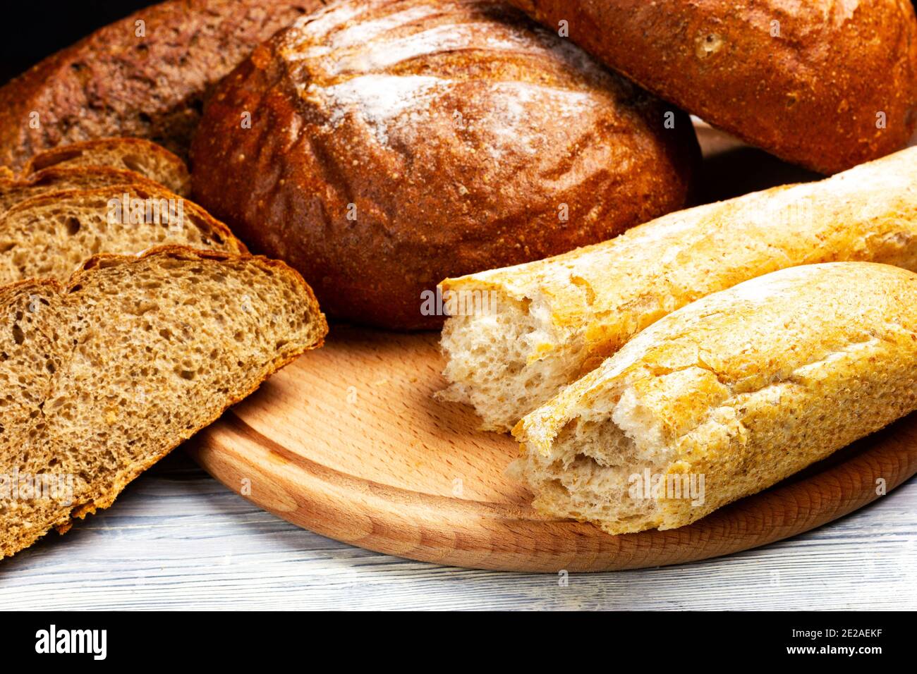 Fresh, crispy bread on a wooden table. Bread counter at the bakery ...