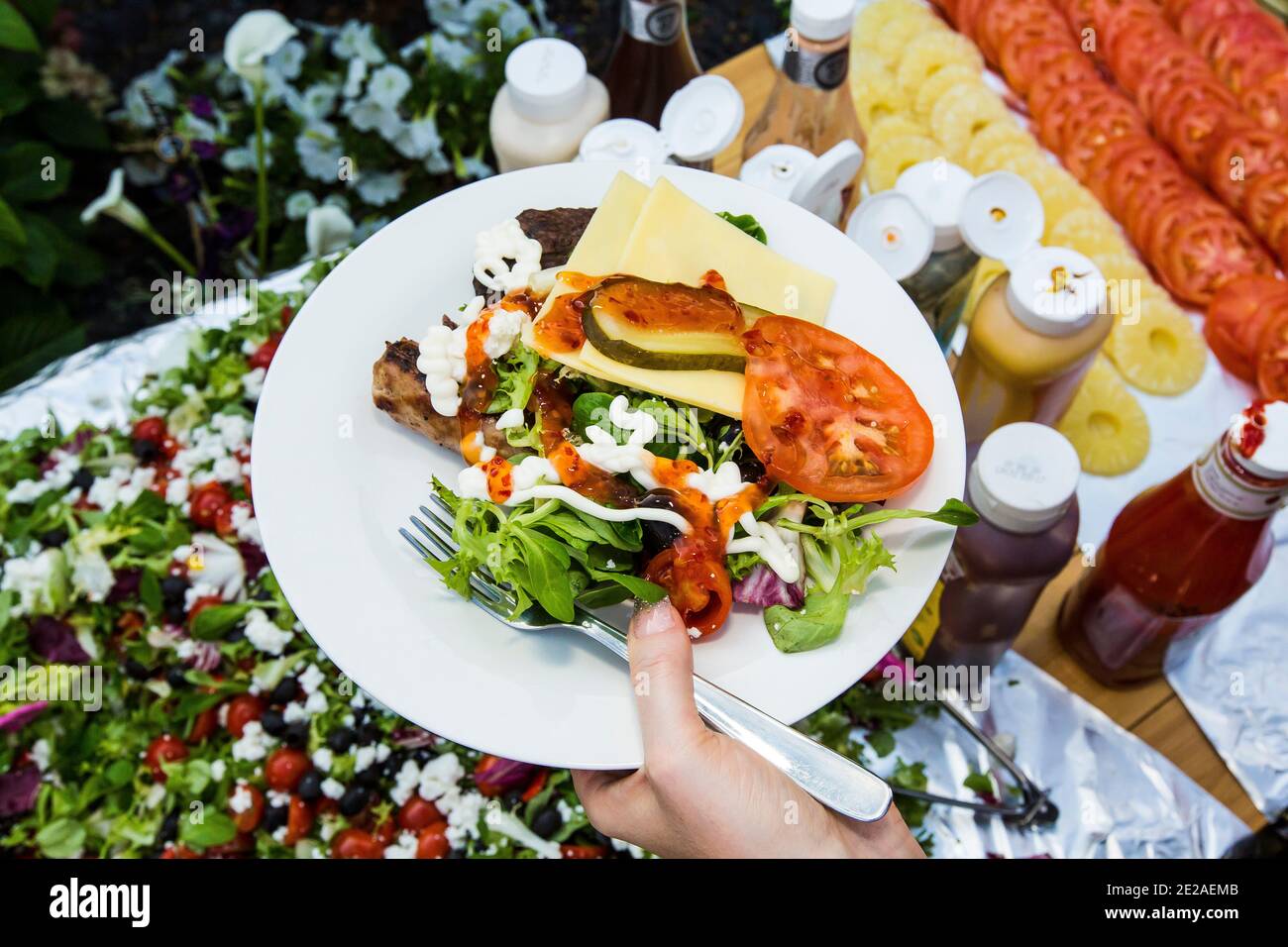 A colourful plate of salad, burger and toppings to build your own ...