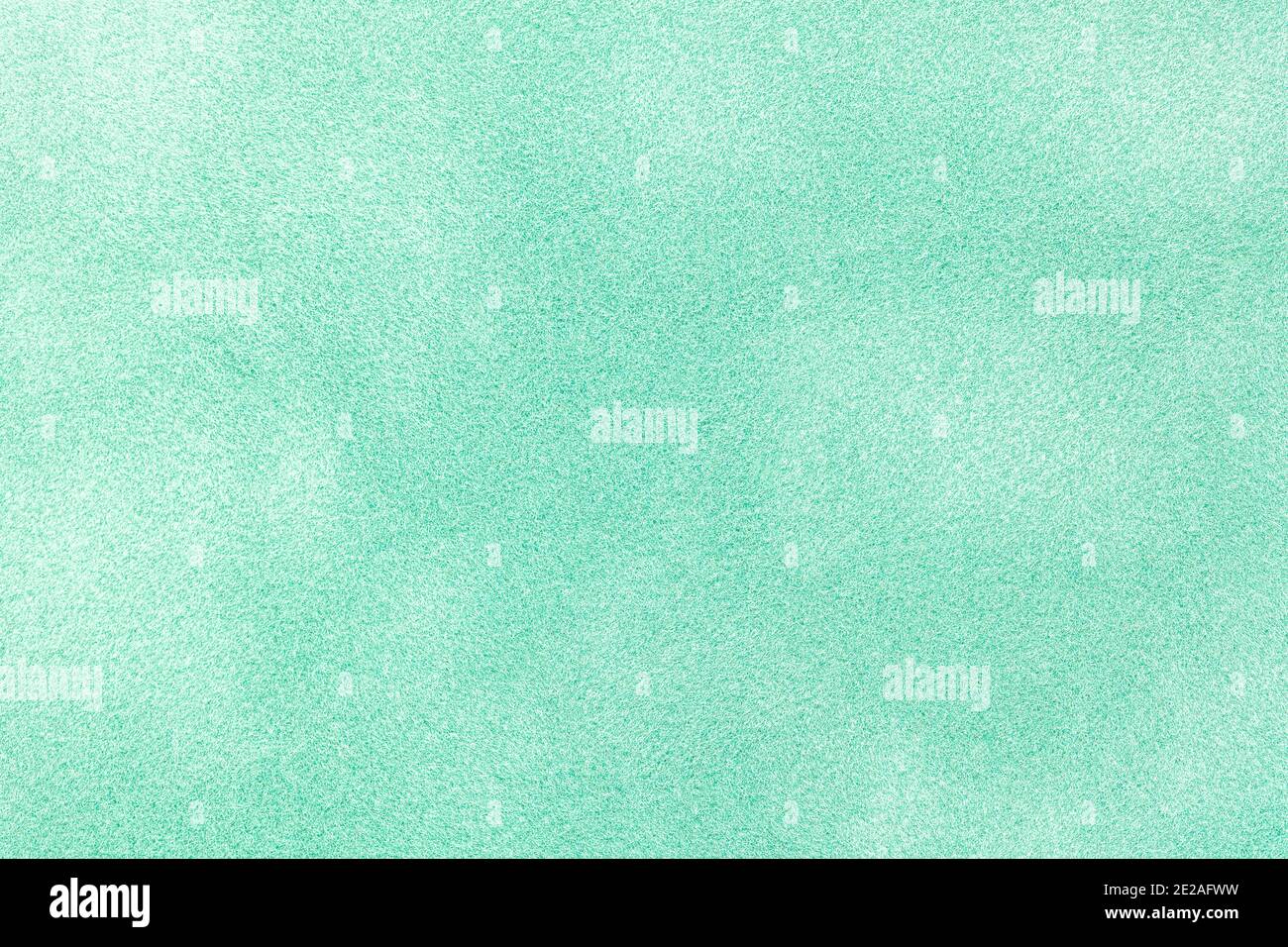 Light green matte background of suede fabric, closeup. Velvet texture ...