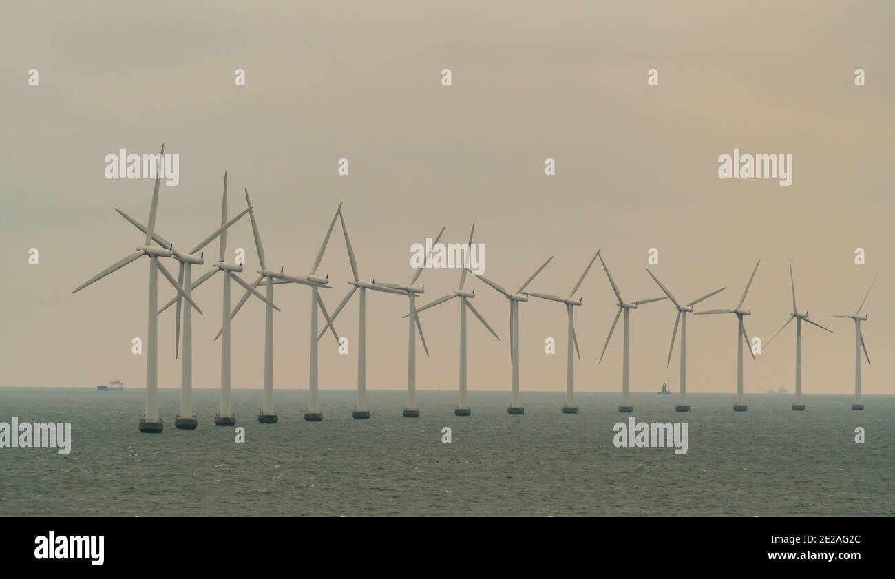 Massive offshore wind turbines generating clean green energy from ocean ... Massive offshore wind turbines generating clean green energy from ocean ...