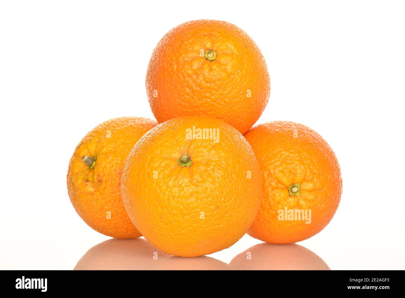 Four ripe organic juicy sweet wholesome oranges, close-up, on a white ...