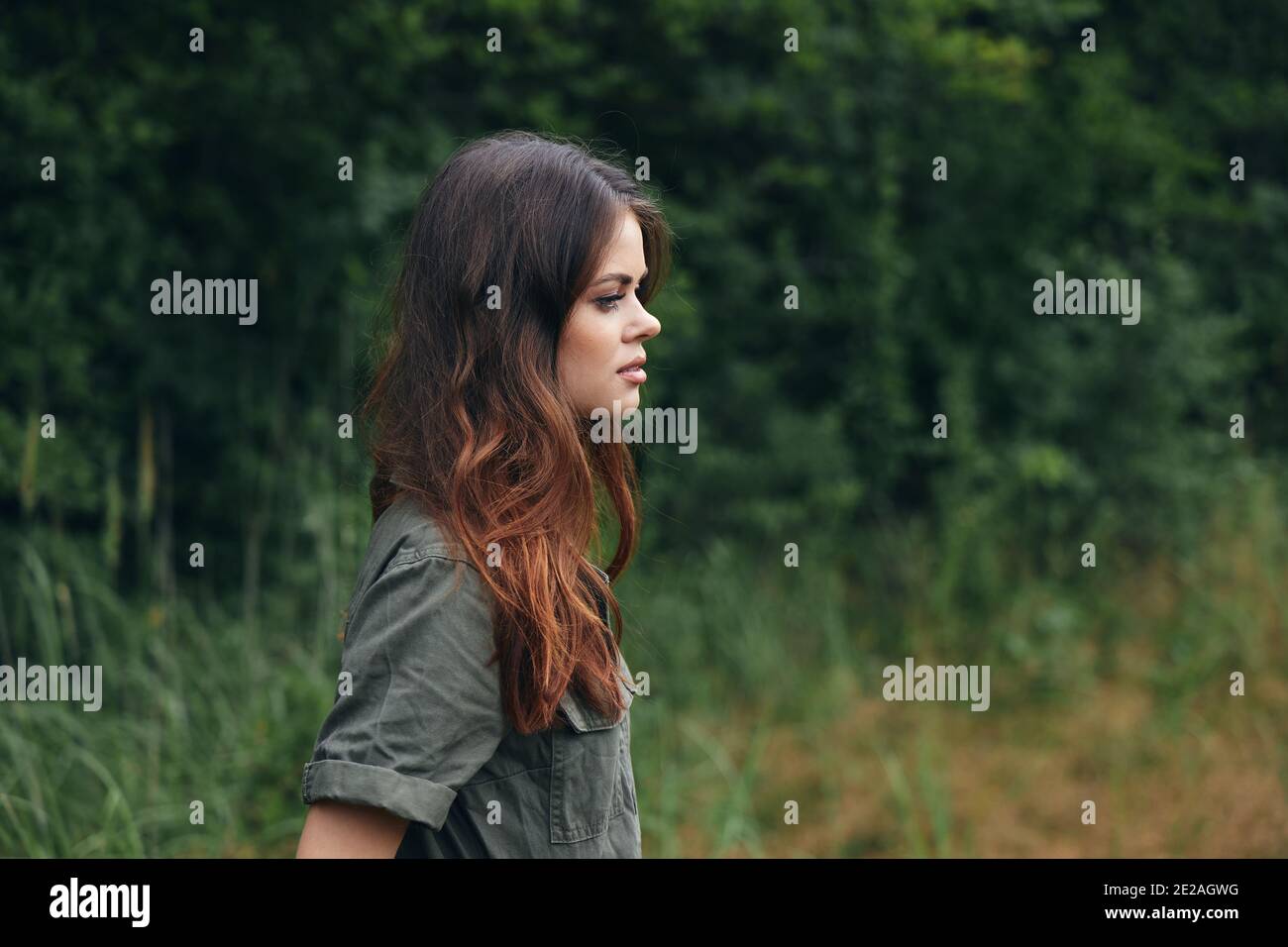 Woman in the forest Side view of a pensive view of a fresh air walk ...