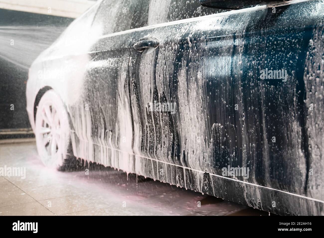 Applying foam to the car. Professional auto wash Stock Photo - Alamy
