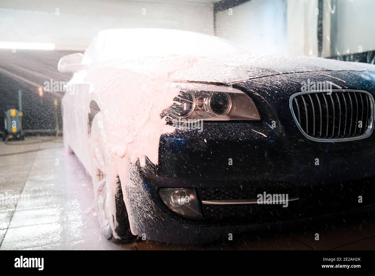 Applying foam to the car. Professional auto wash Stock Photo - Alamy
