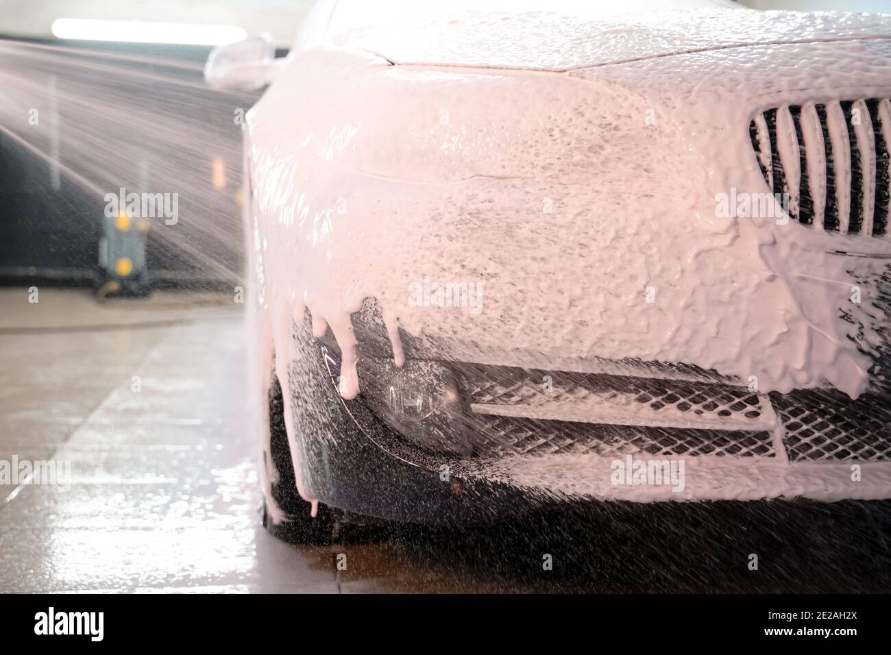 Applying foam to the car. Professional auto wash Stock Photo - Alamy