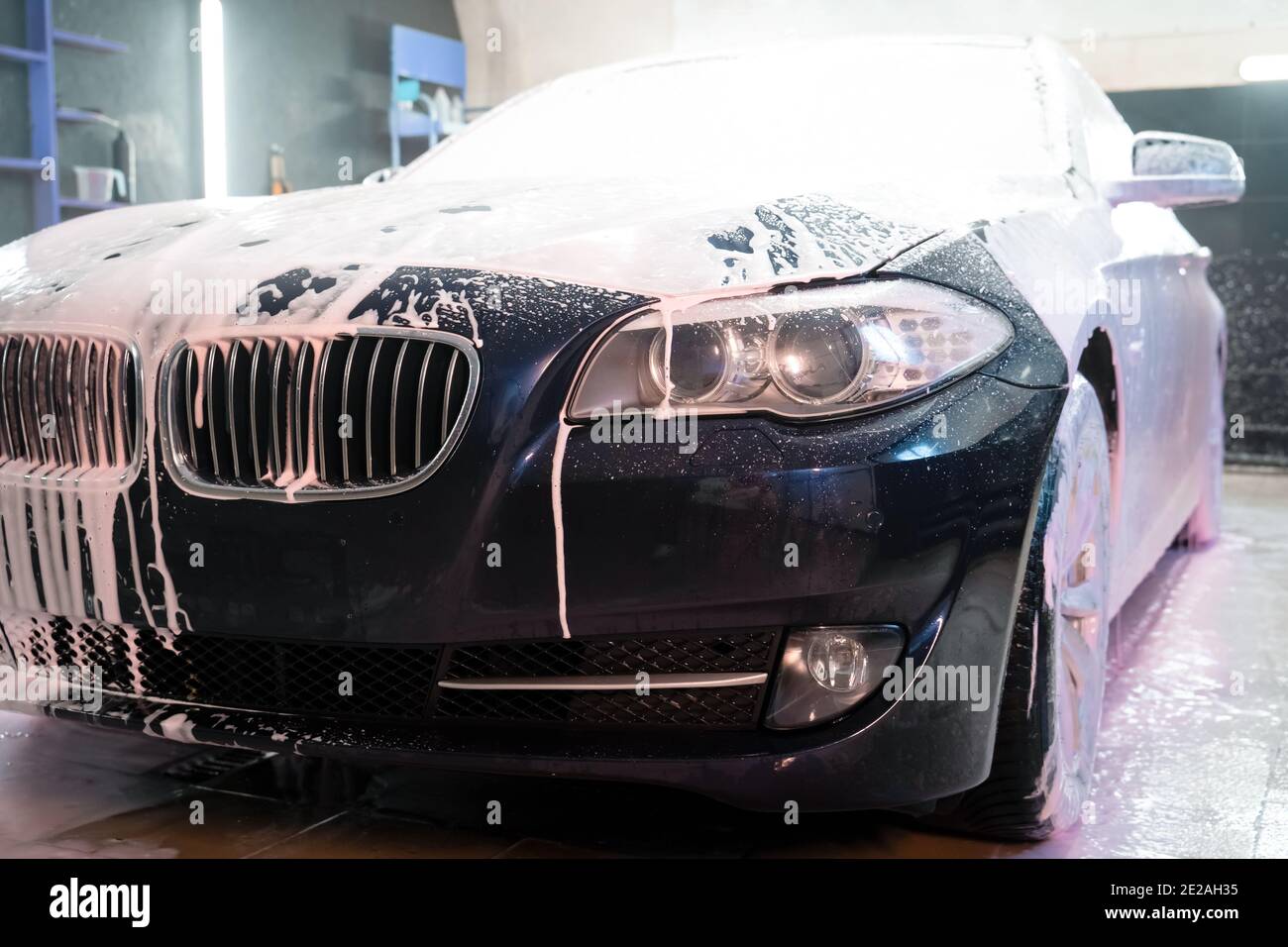 Applying foam to the car. Professional auto wash Stock Photo - Alamy