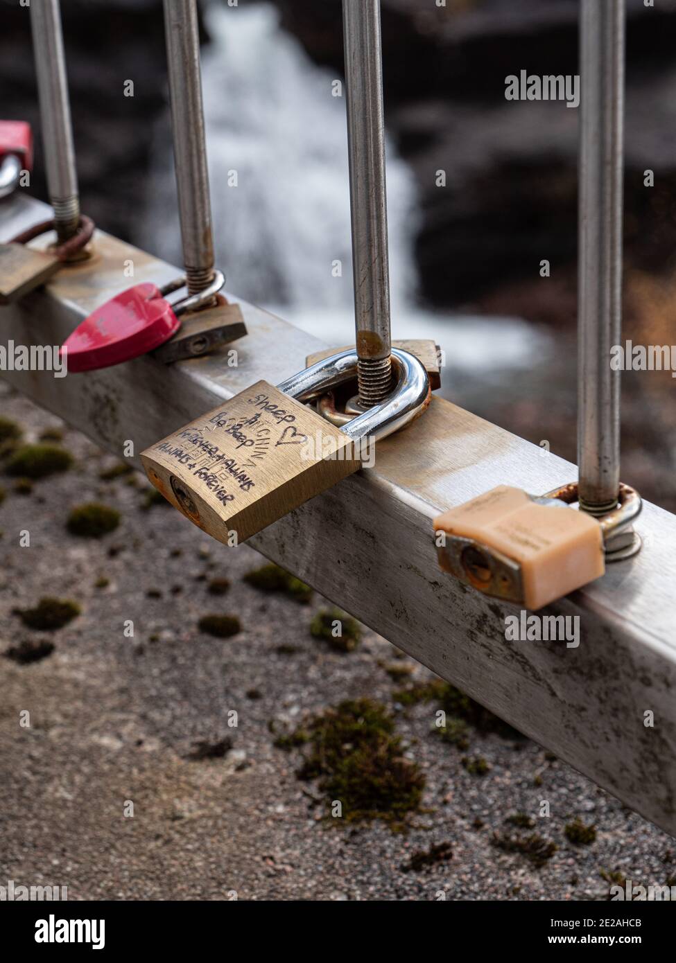 Padlocks secured to the railings of a bridge in Glencoe Scotland UK ...