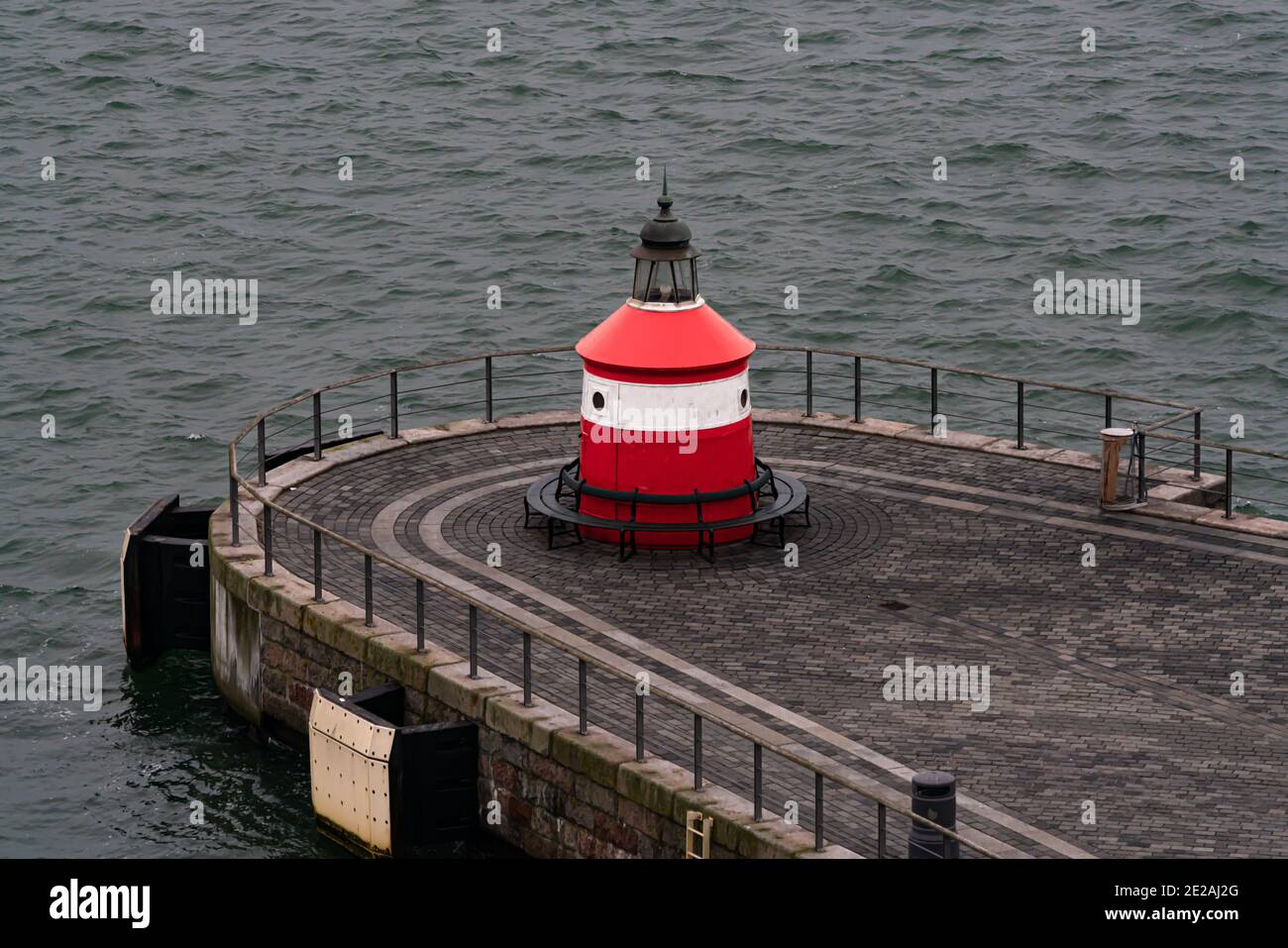 Small red lighthouse at the on of a pier Stock Photo - Alamy