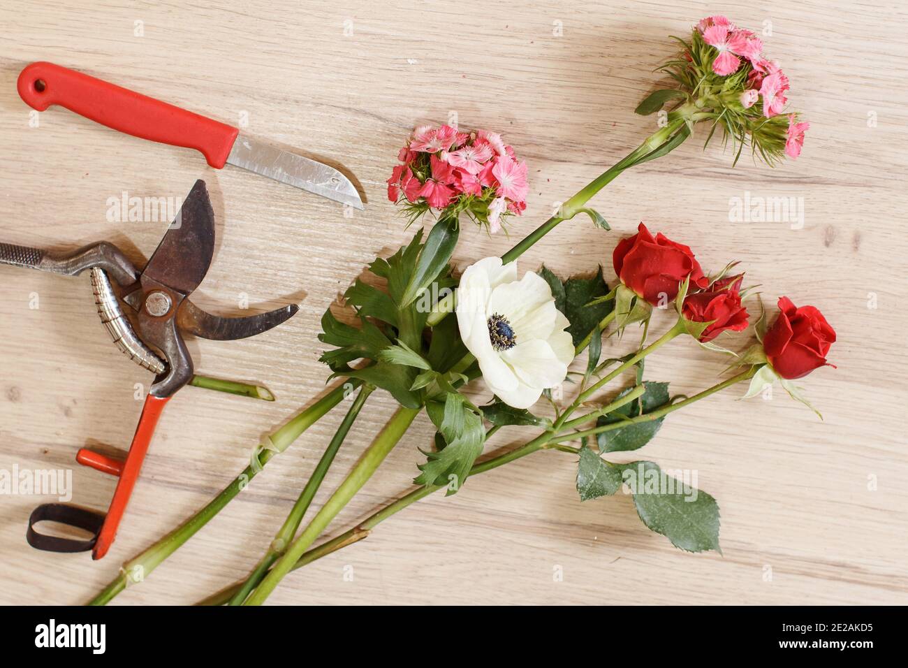 Cutting a flowers at flower shop, op view Stock Photo - Alamy
