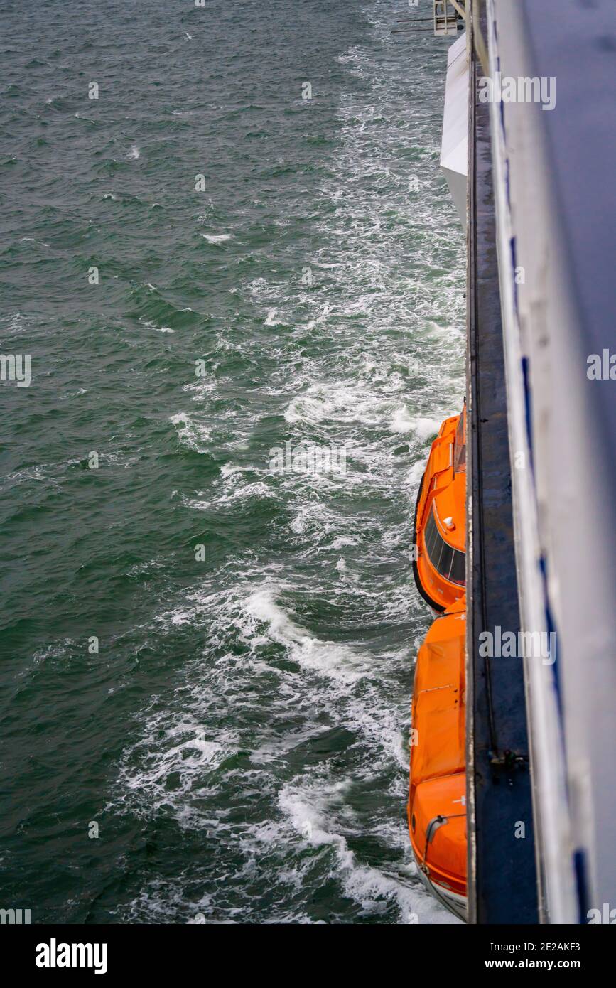 Life boats and wake water from a cruise ship at sea Stock Photo - Alamy