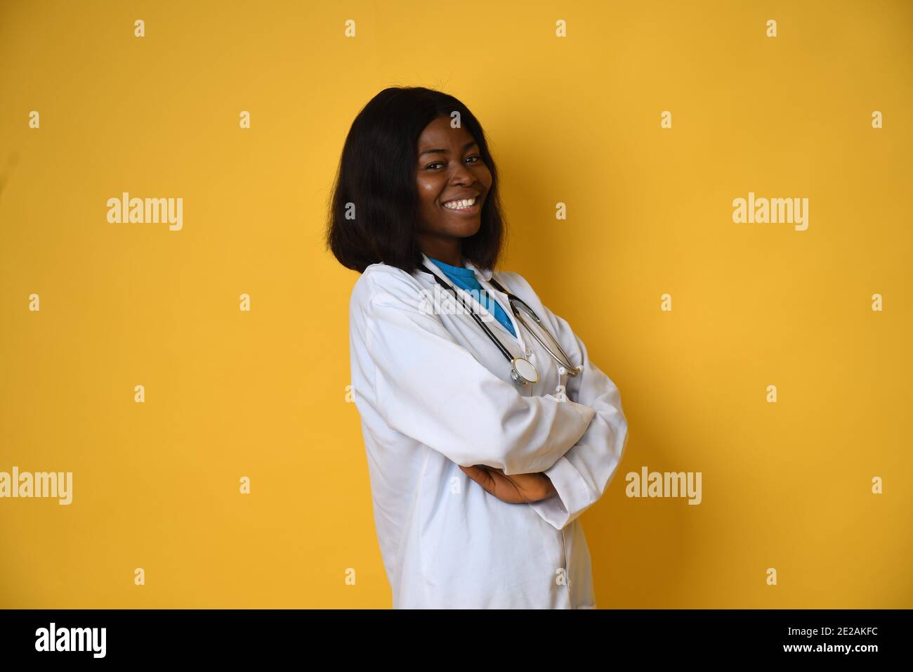 a portrait of an african nurse, a yellow background Stock Photo - Alamy