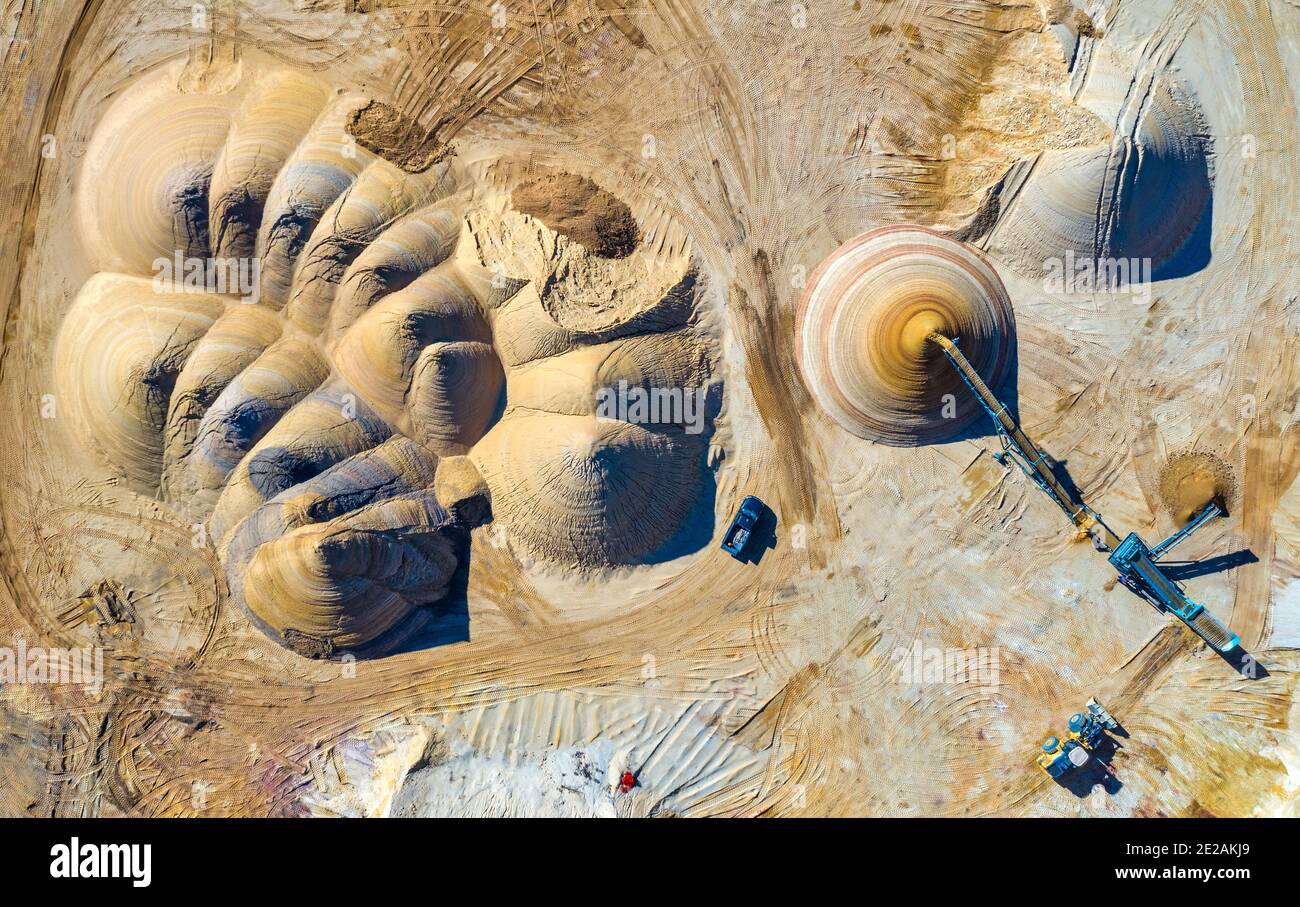 Aerial photo of mounds of sand being moved with a convveyor and front ...