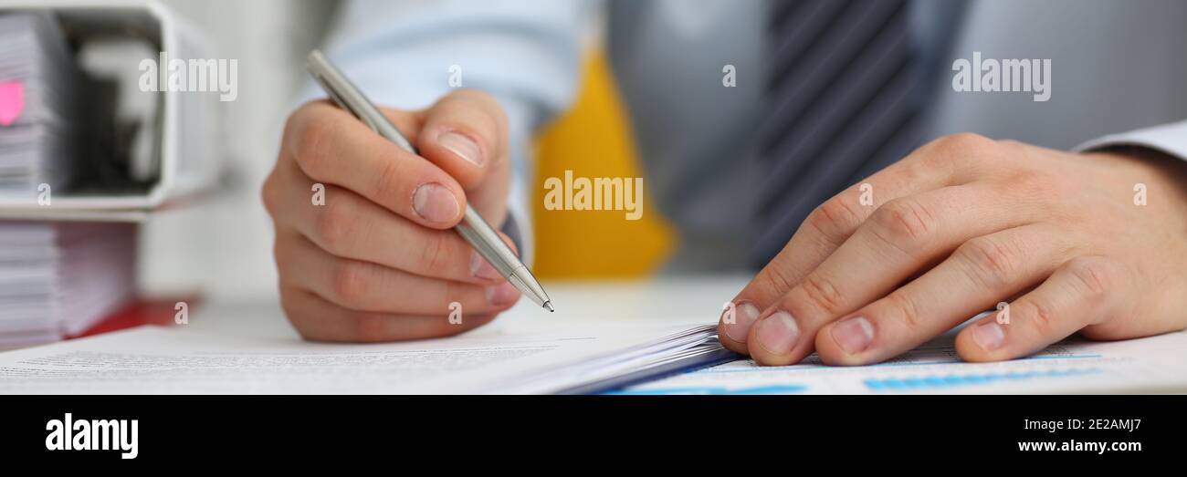 Male doing paper work in office with pen Stock Photo - Alamy