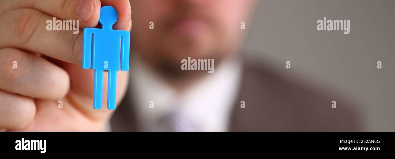 Man in suit using plastic little figures Stock Photo - Alamy
