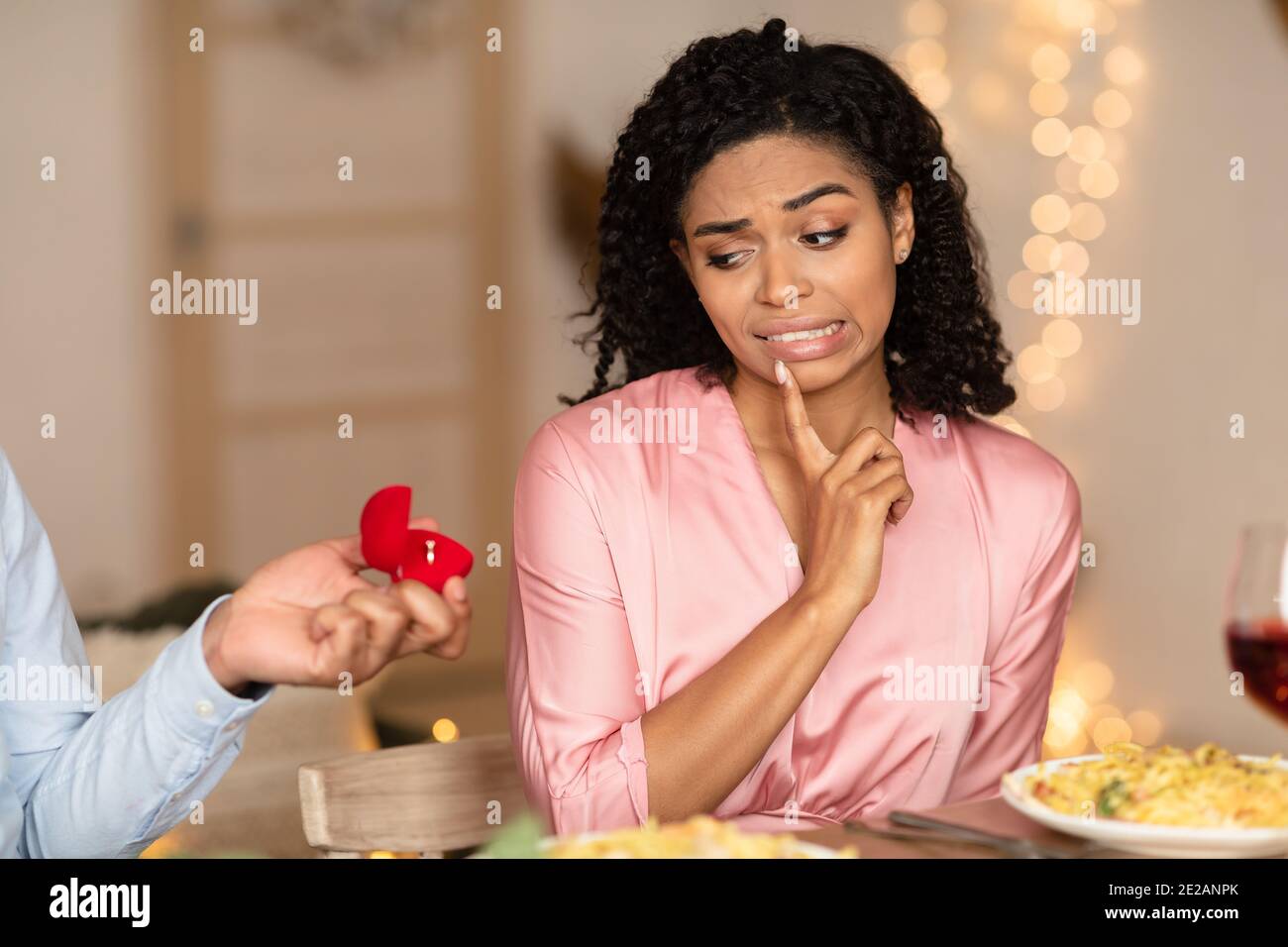 Black man making proposal with ring, woman rejecting Stock Photo - Alamy