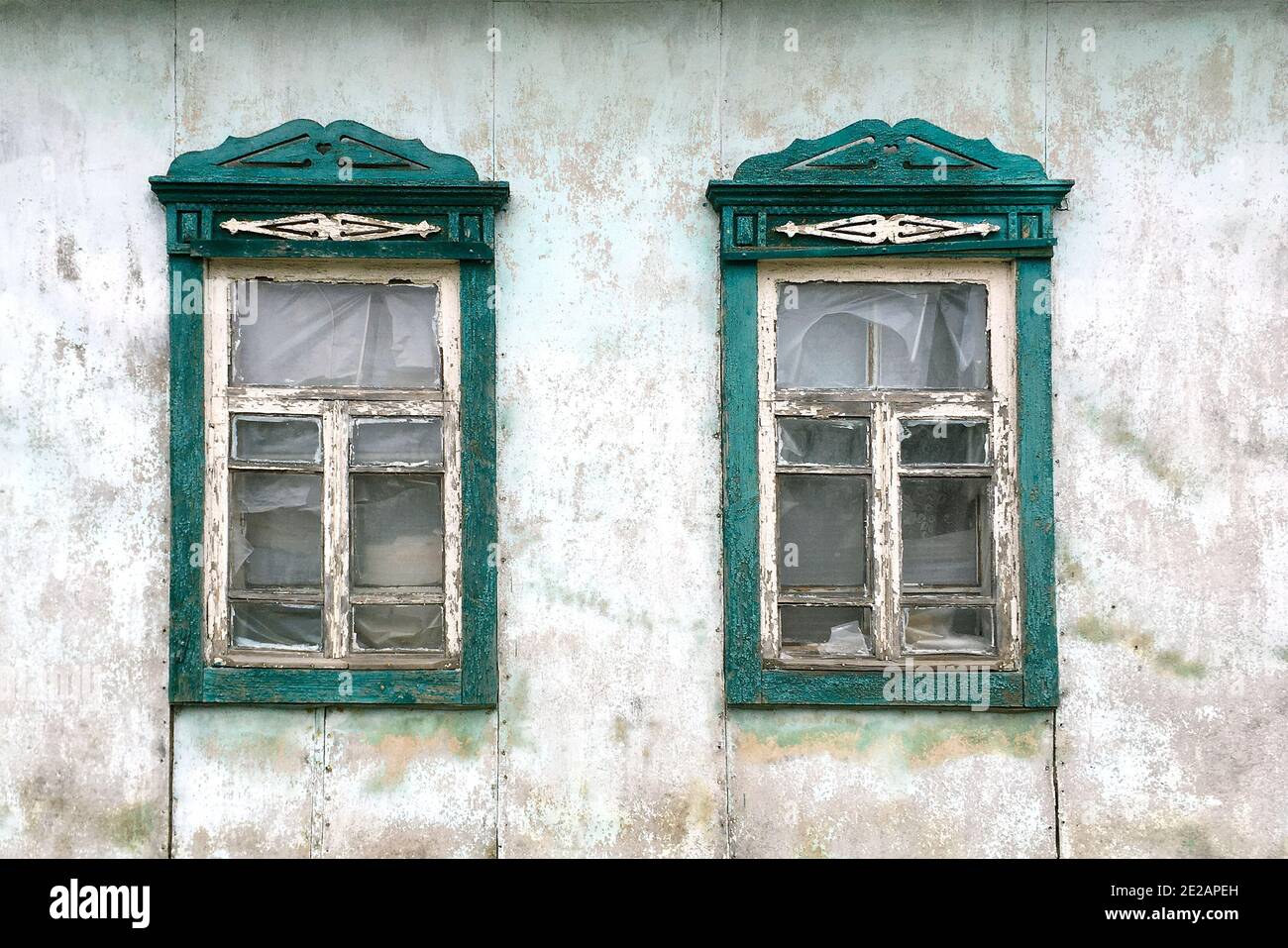 Two wooden windows in abandoned old countryside house. View of an old ...