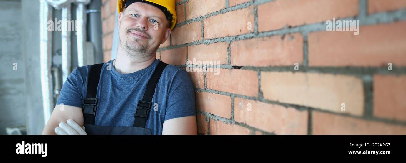 Happy male builder relaxing after hard working day Stock Photo - Alamy