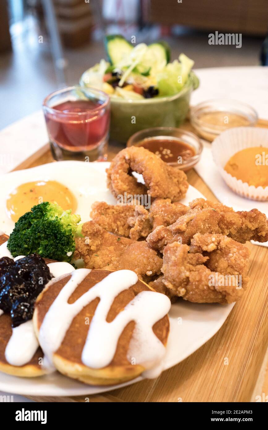 Classic USA breakfast. fried chicken, pancakes waffles, fried eggs ...