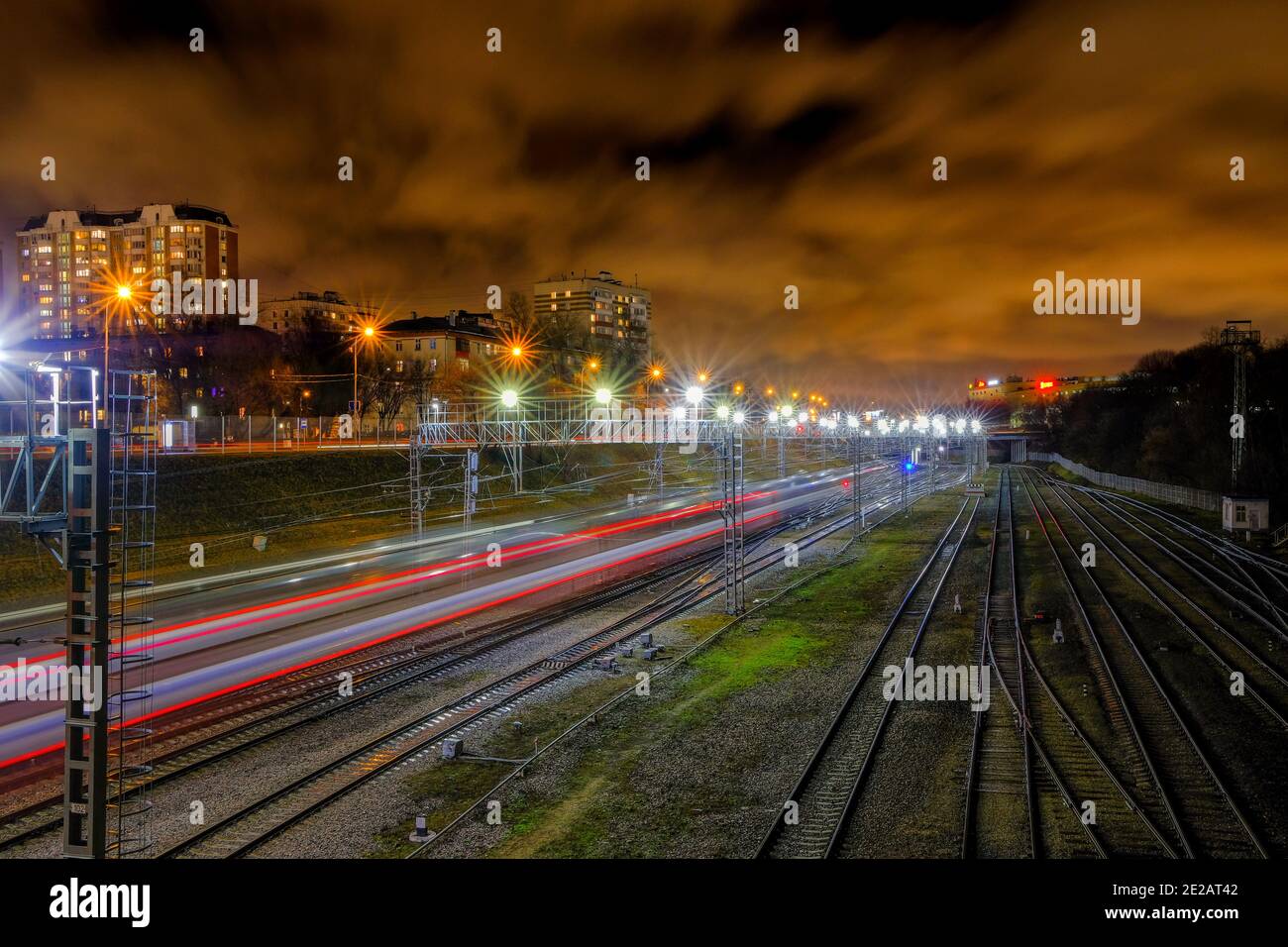 The blurred red line of lights from a train rushing into the distance ... The blurred red line of lights from a train rushing into the distance ...