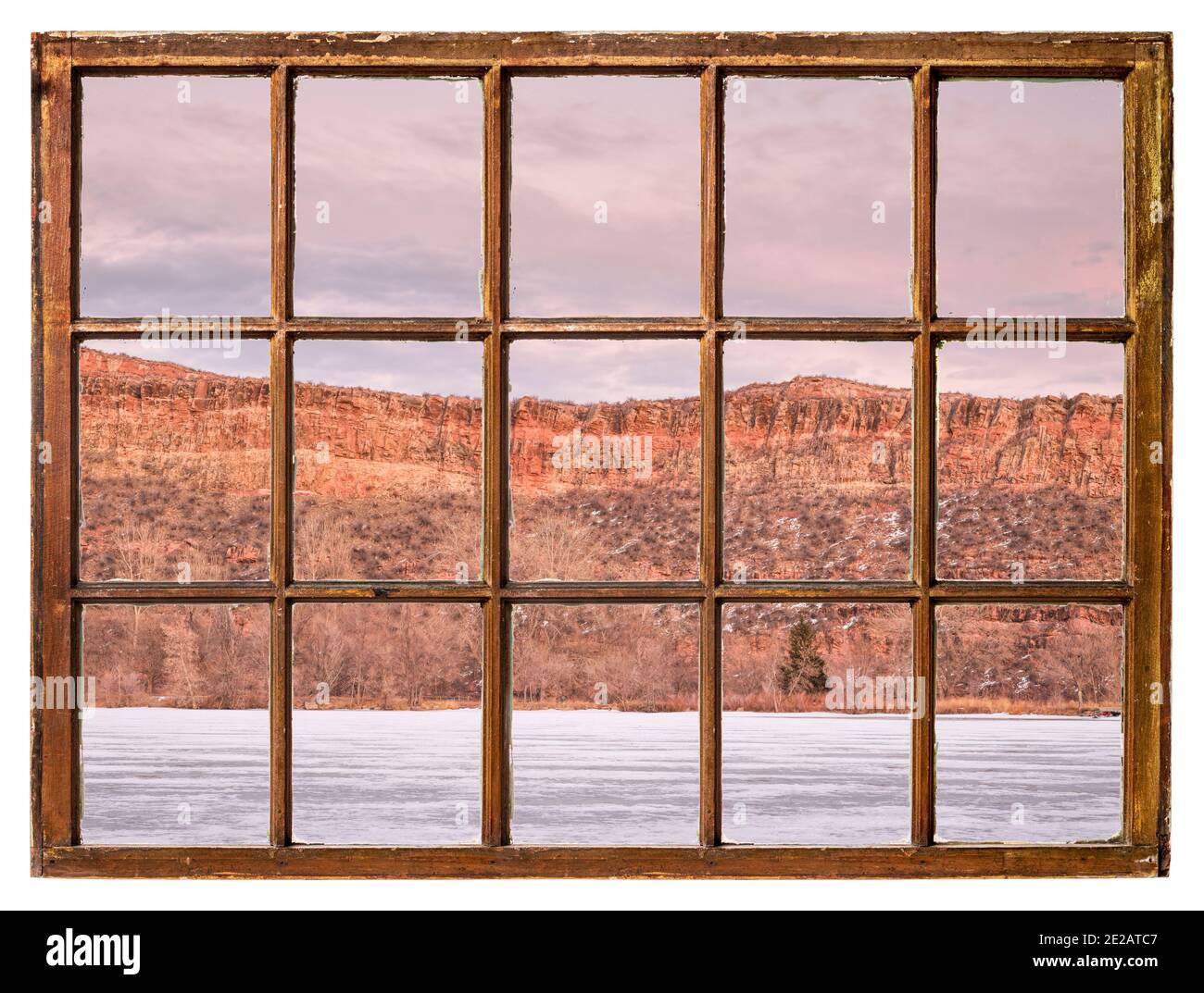 Calm dusk over Colorado foothills with frozen lake and sandstone cliff ...