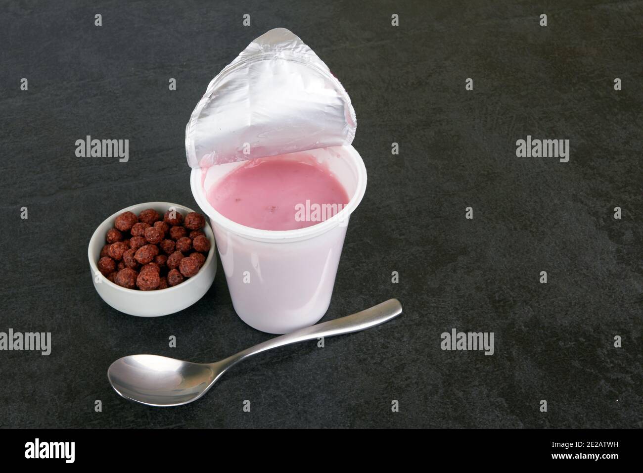 Fruit yogurt on a dark stone surface Stock Photo - Alamy