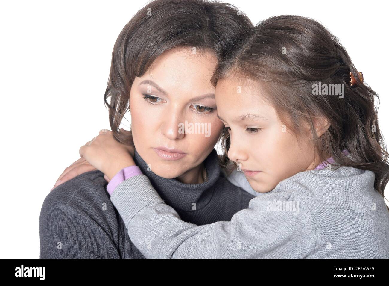 Portrait of sad woman and girl hugging Stock Photo - Alamy