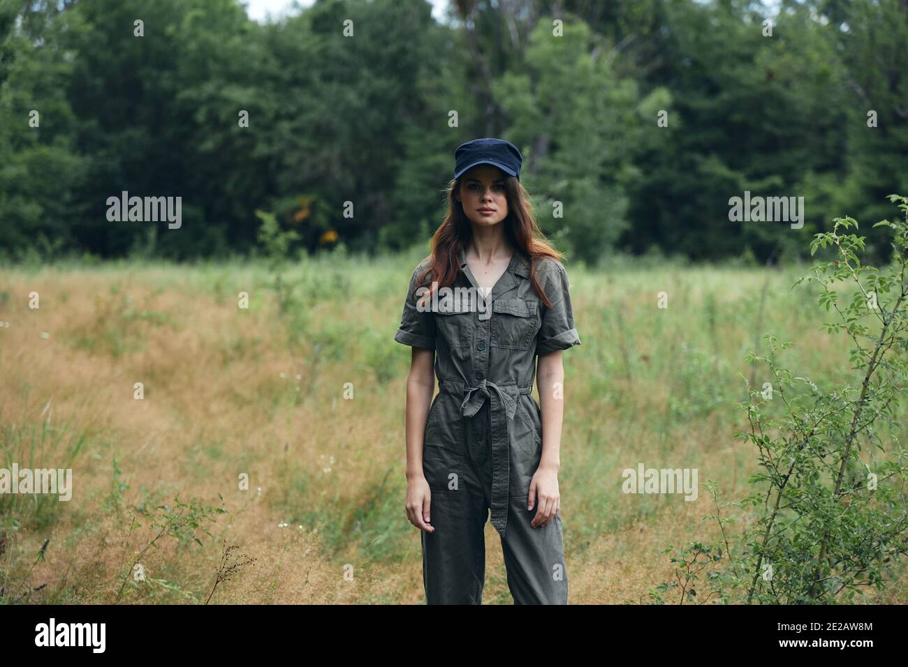 woman in nature in a gray overalls and a cap on her head Stock Photo ...