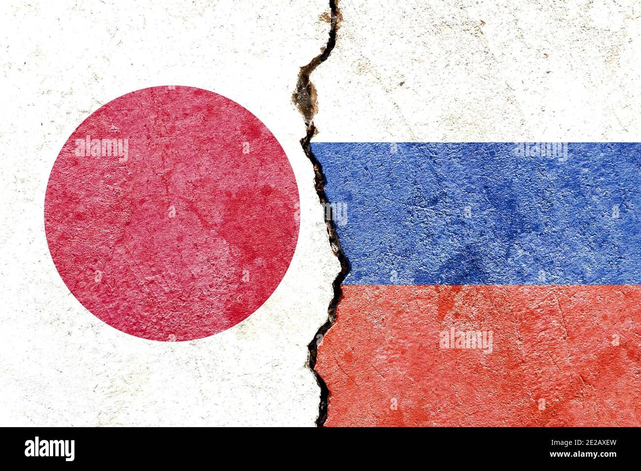 View of Japan vs Russia flags on weathered cracked concrete wall ...