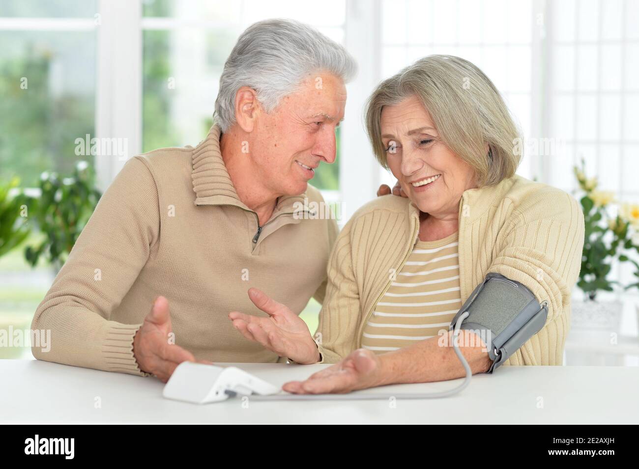 Portrait of senior couple measuring blood pressure together Stock Photo ...