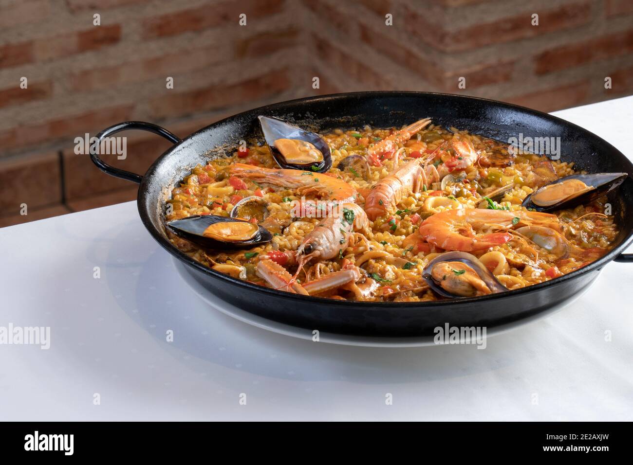 Spanish seafood Paella ,with crayfish, squid, mussel and prawn, in an ...