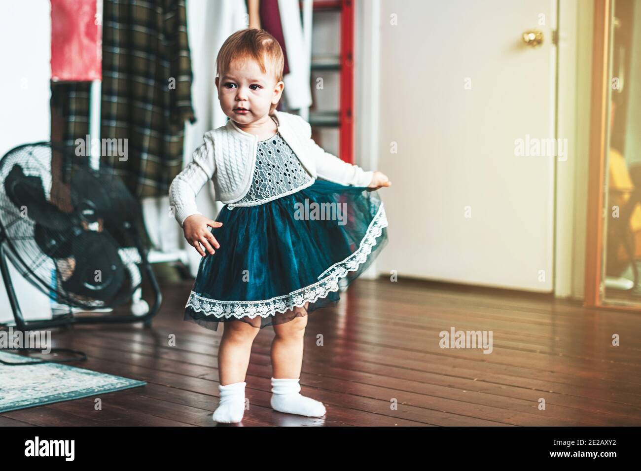 Cute one year old girl in a beautiful dress Stock Photo - Alamy