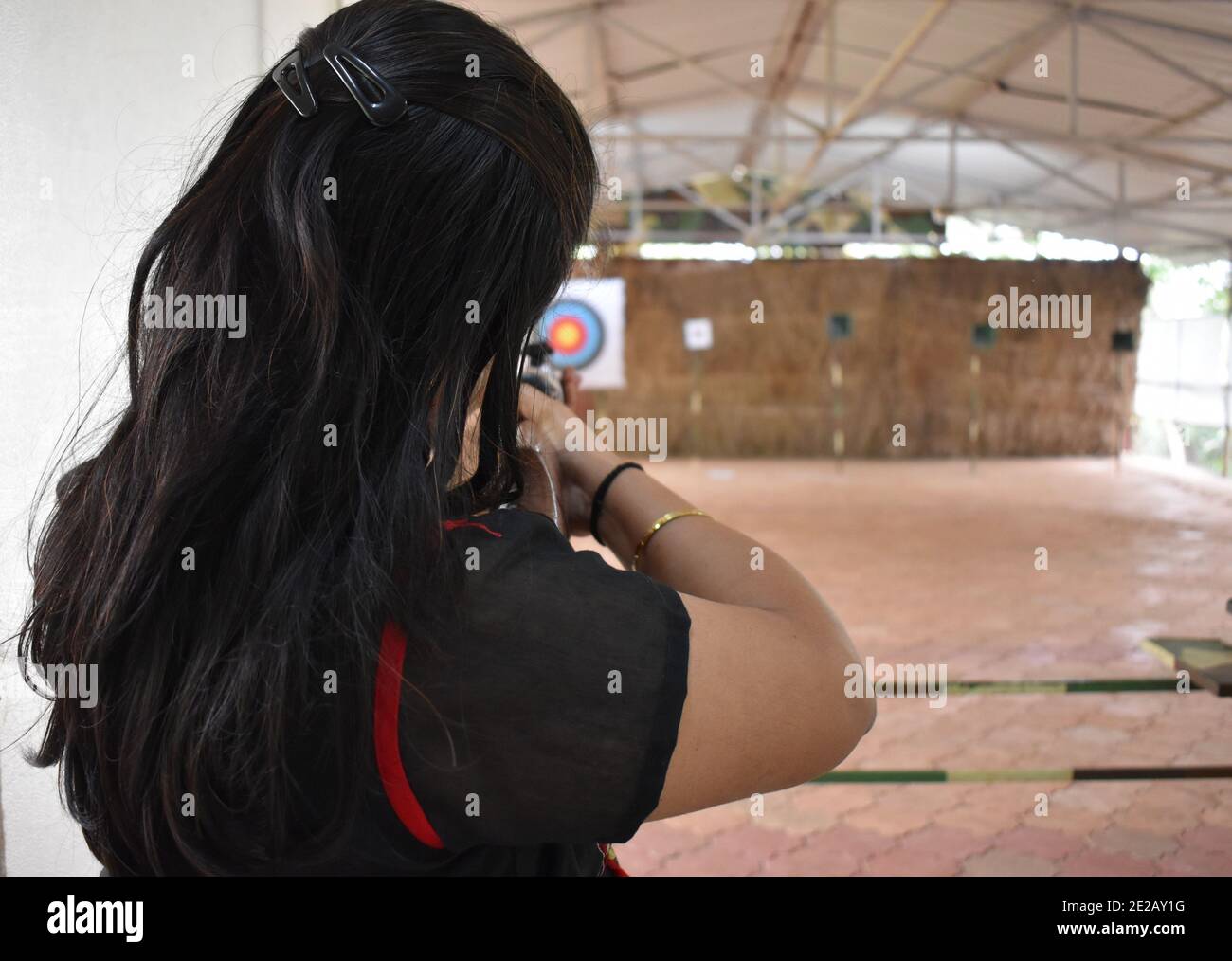 Woman shooting in shooting range Stock Photo - Alamy
