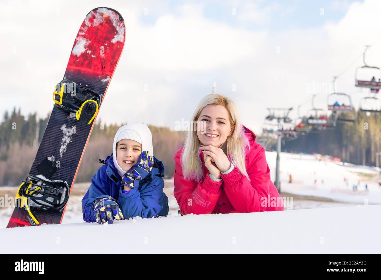 mother and daughter with snowboards in a mountain resort Stock Photo ...